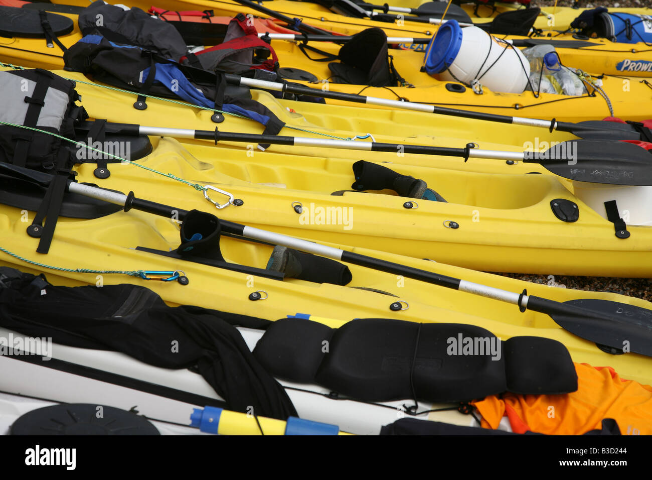 Yellow kayaks on shore Stock Photo - Alamy