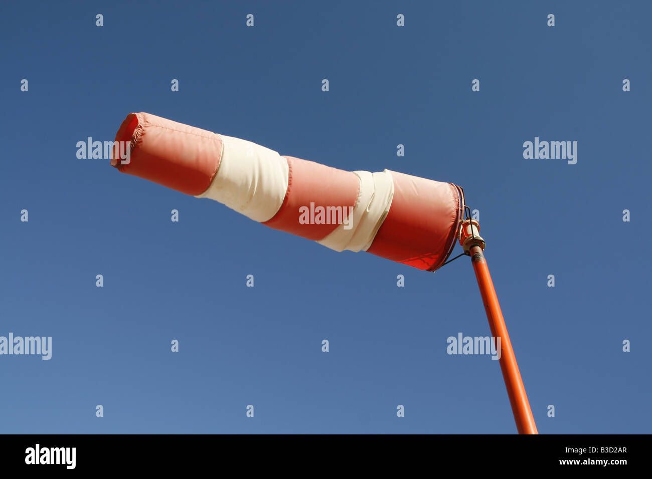 one wind sock blowing in wind at plane airport Stock Photo - Alamy
