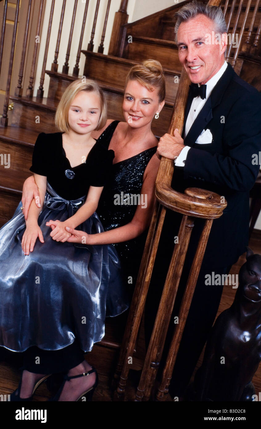 Family dressed for elegant occasion, embracing, together, happy and ...