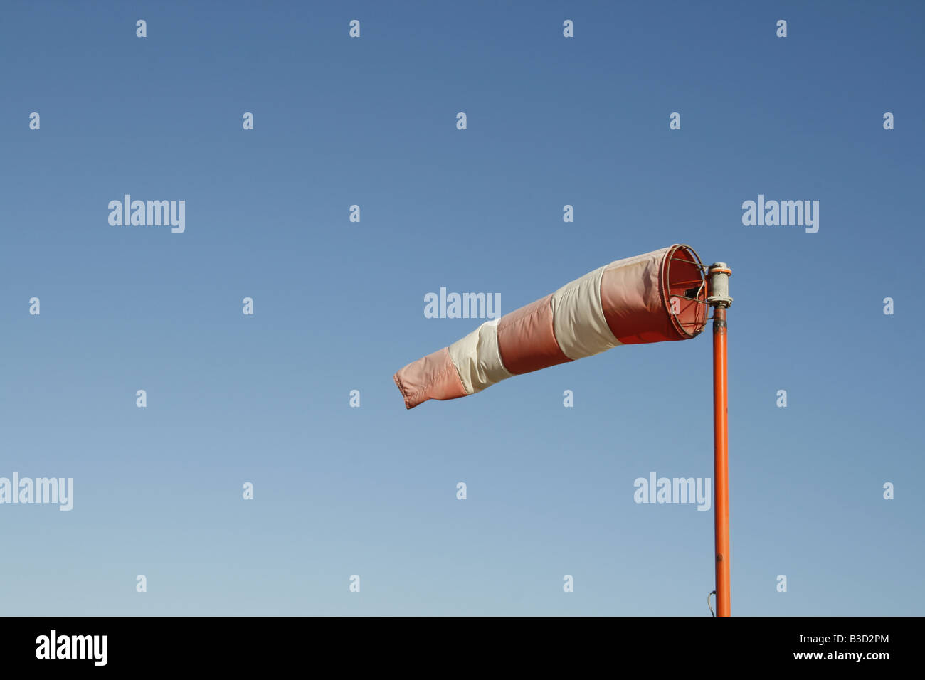 one wind sock blowing in wind at plane airport Stock Photo - Alamy