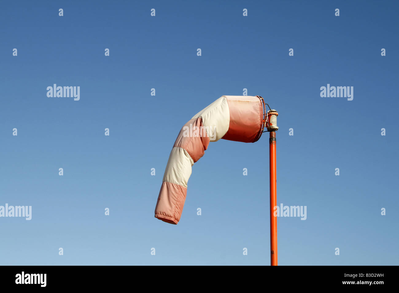one wind sock blowing in wind at plane airport Stock Photo - Alamy