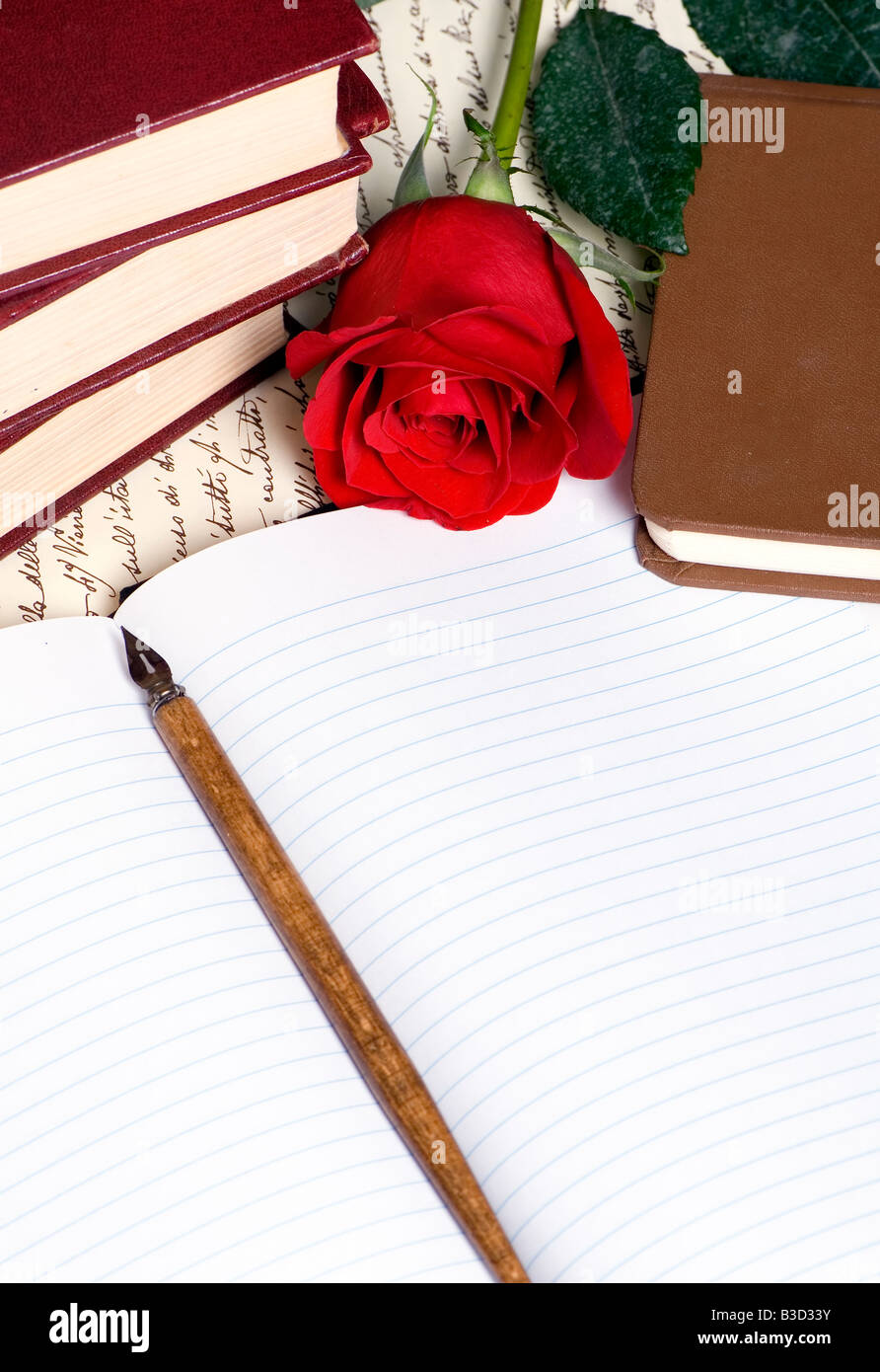 A single red rose with an open book ready for writing Stock Photo - Alamy