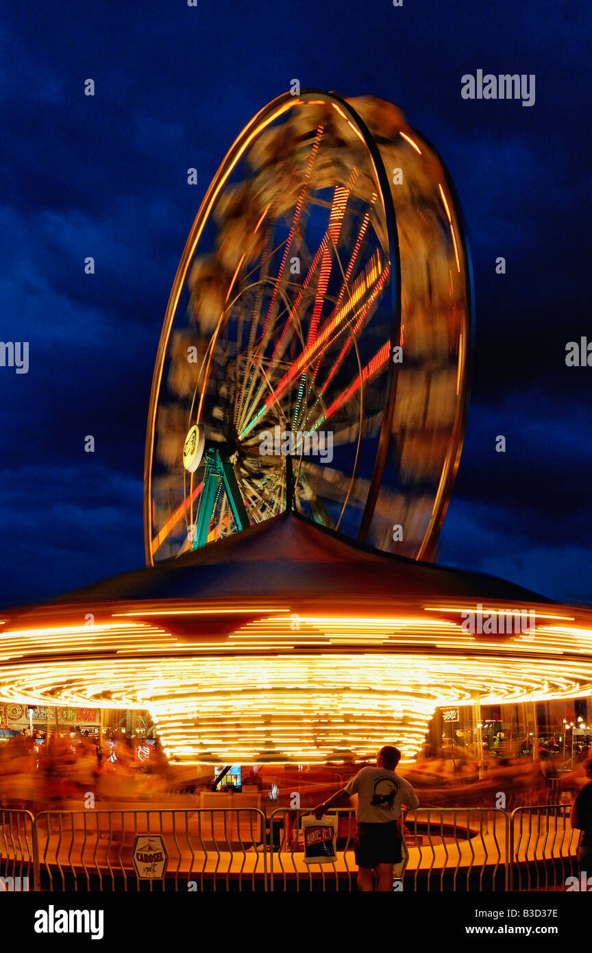 Man Watching Carousel with Movement Blur at Dusk at the Kentucky State ...