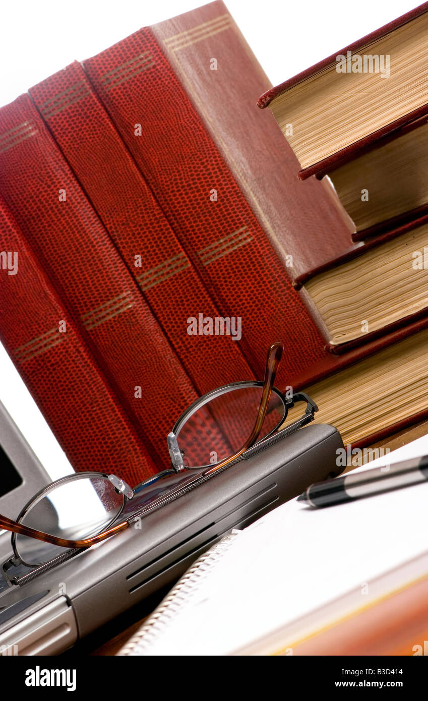 A laptop computer with books all around Working on a paper Stock Photo ...