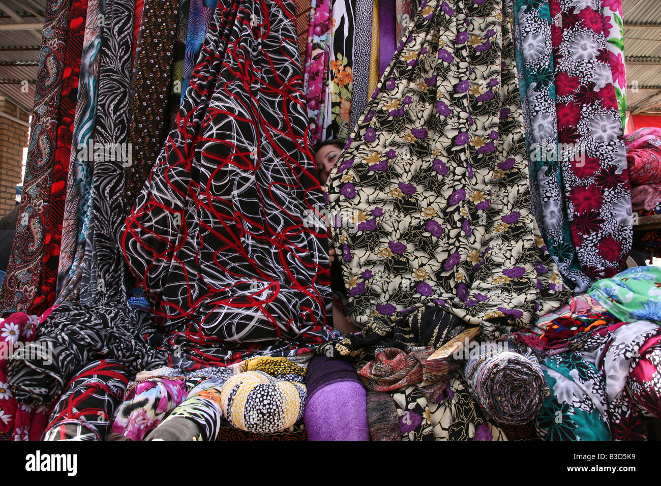 Vendor selling textile at the central market in Urgench, Uzbekistan ...