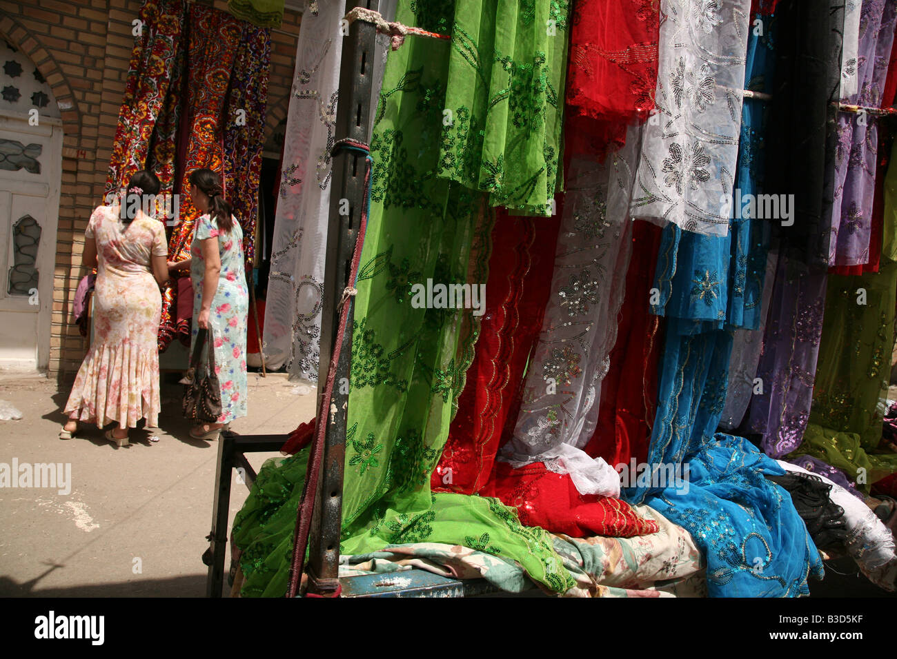 Vendor selling textile at the central market in Urgench, Uzbekistan ...