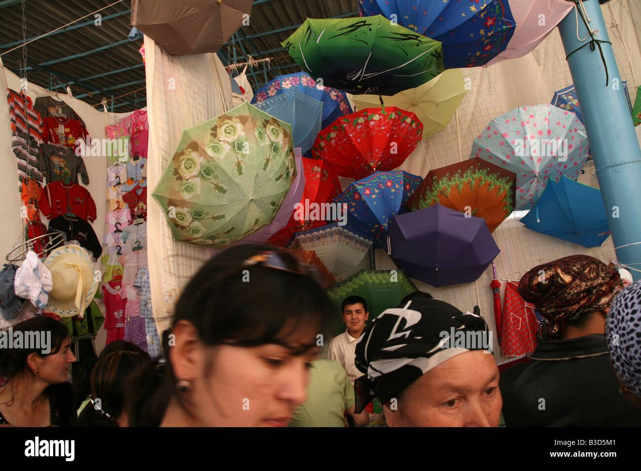 Vendor selling umbrellas at the central market in Urgench, Uzbekistan ...