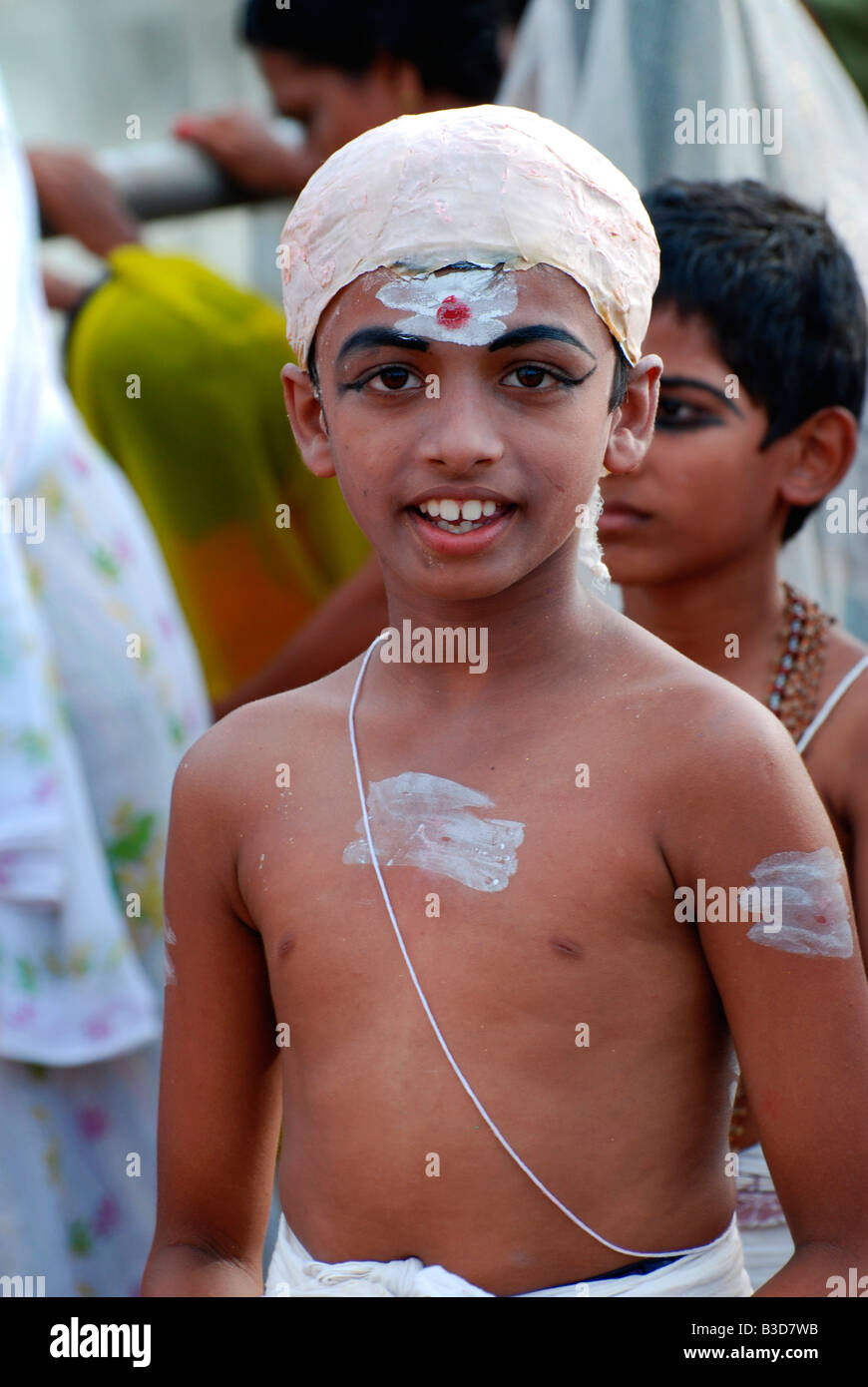 A boy posing as hindu priest in a religious procession in Kerala,India ...
