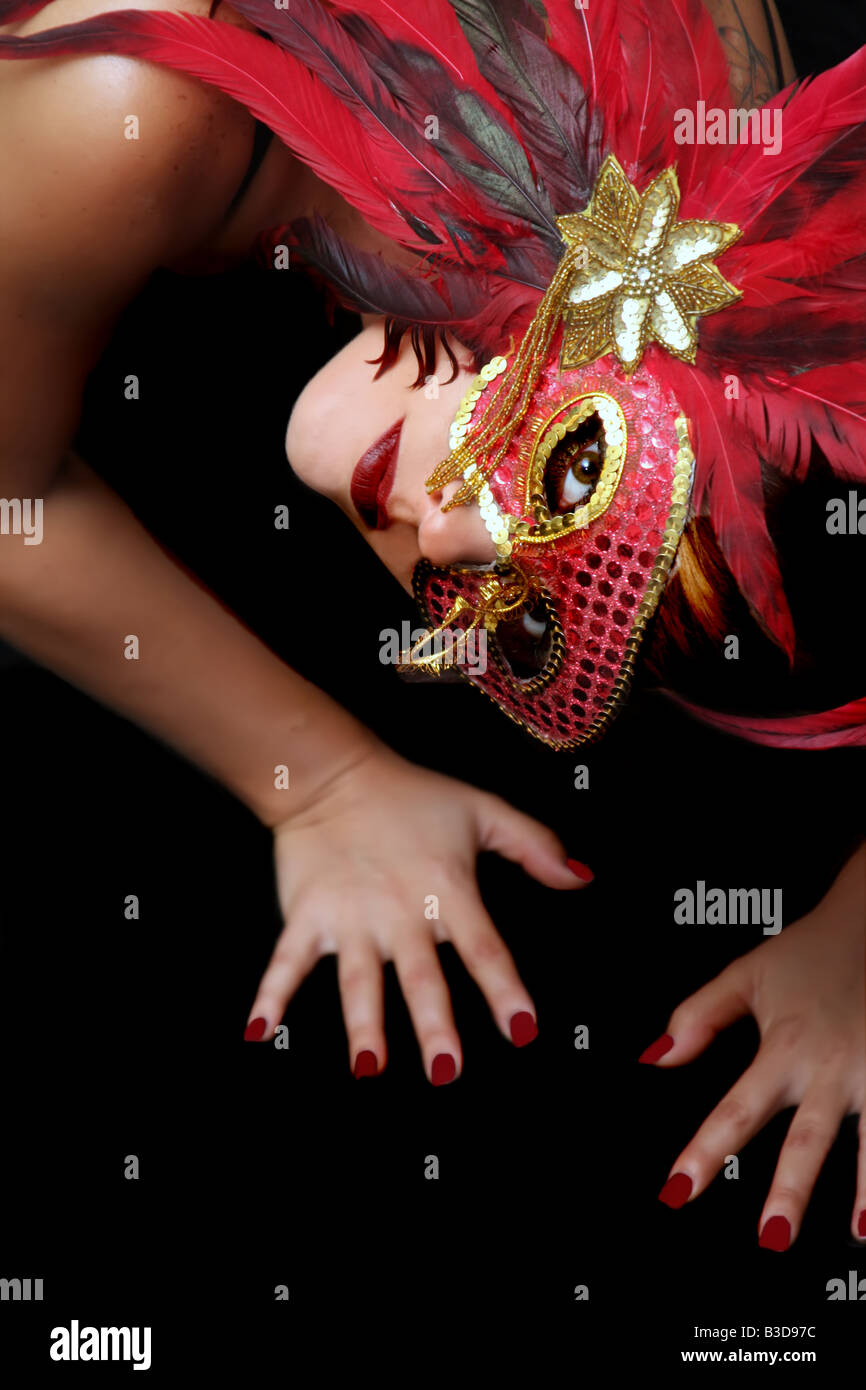 stock photo of woman in red feathered mask Stock Photo - Alamy