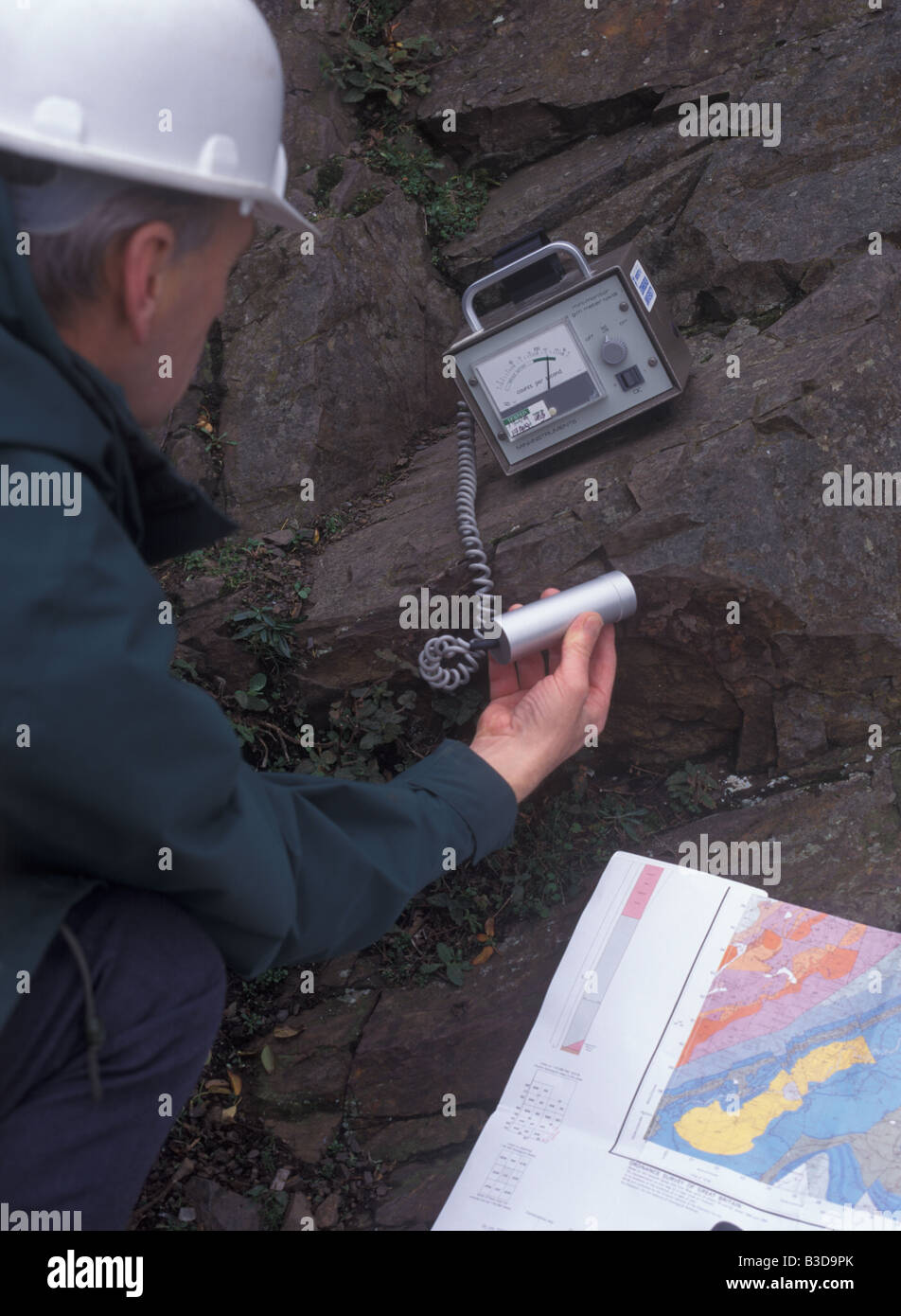 A geologist uses a geiger counter while examining rocks Stock Photo - Alamy