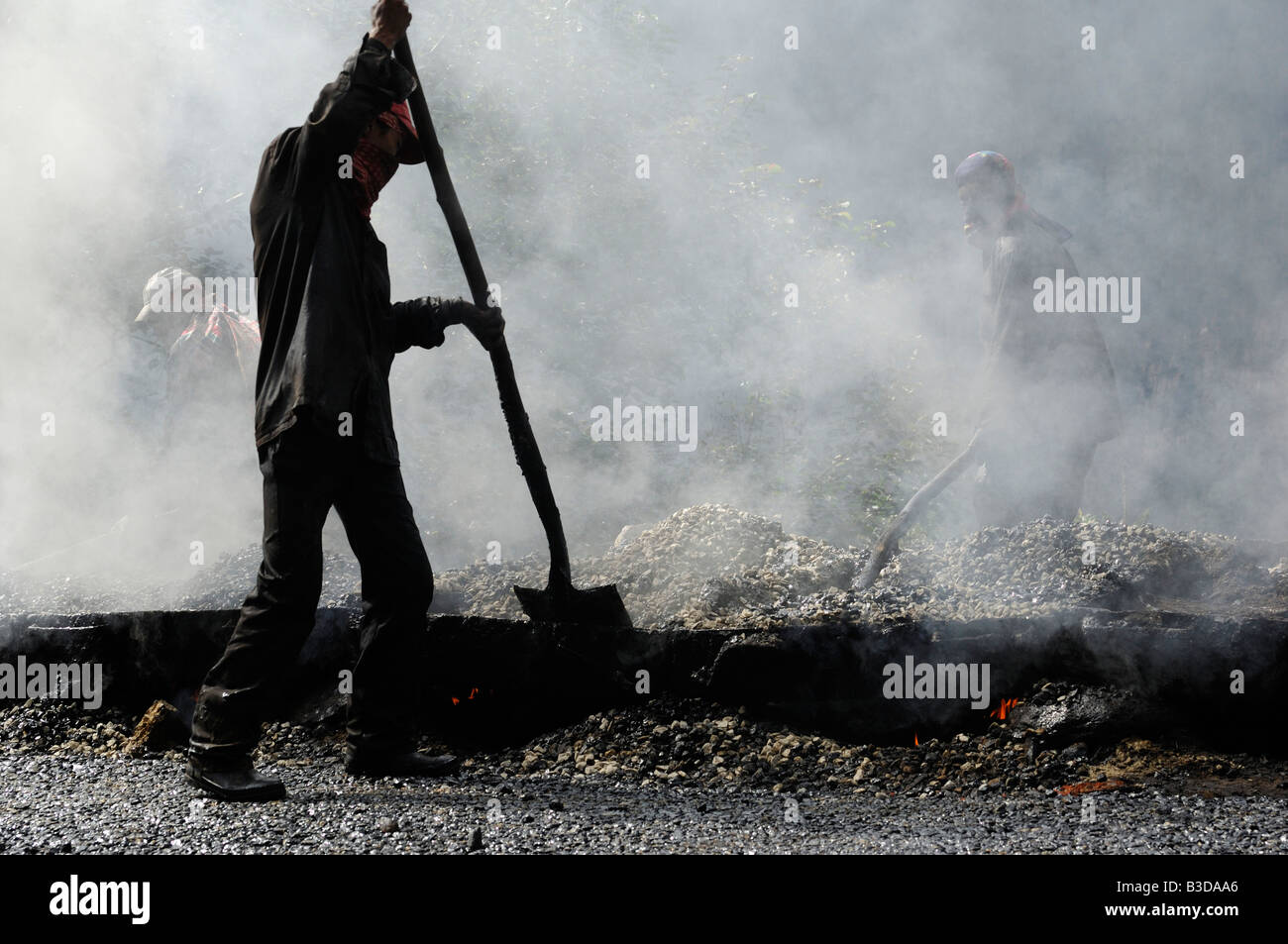 Road workers preparing tar in India Stock Photo - Alamy