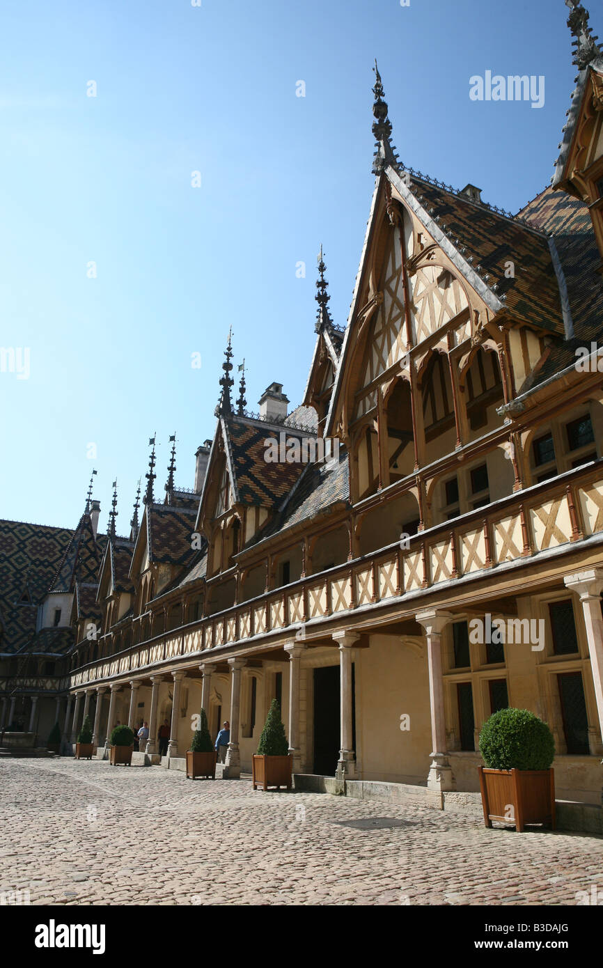 The central courtyard Cour d' Honneur and wooden gallery of the Hospice Hotel-Dieu in Beaune ...