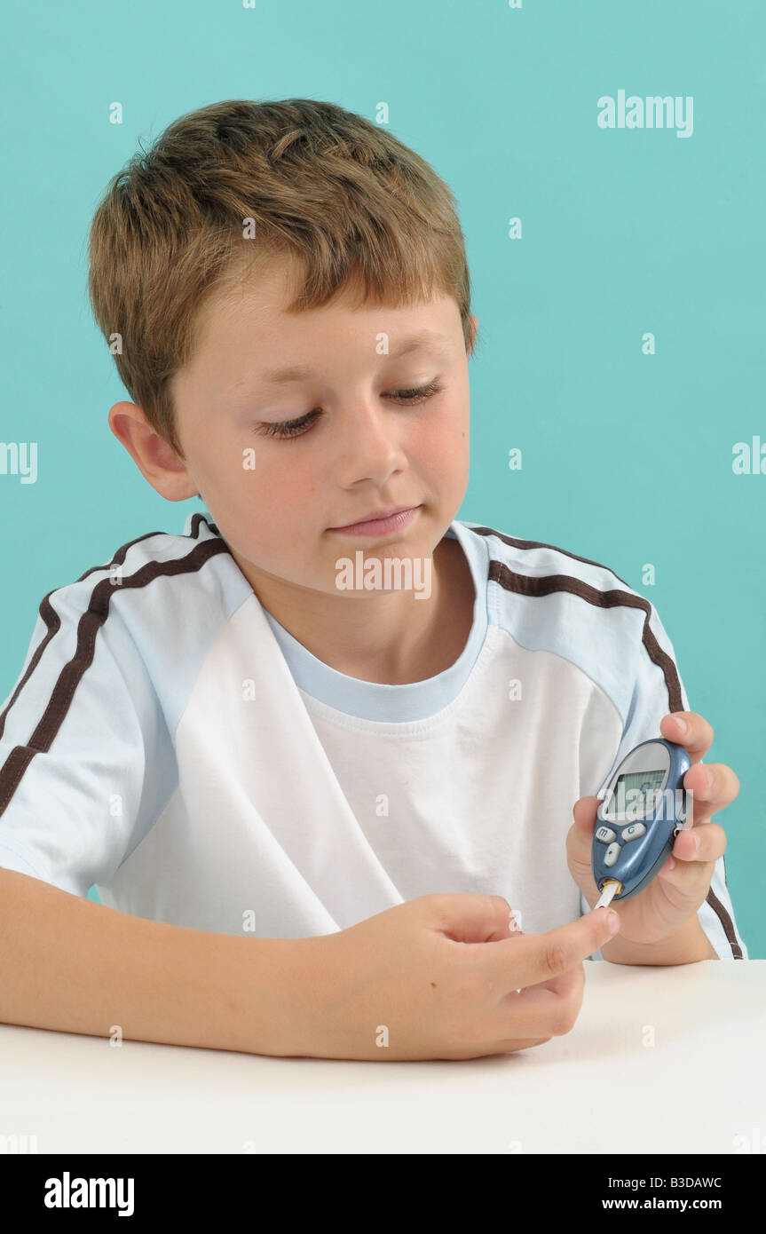 Young boy doing blood glucose test Stock Photo - Alamy