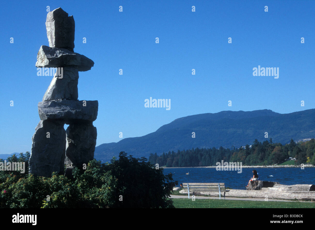 Inuit Inukshuk or Inuksuk sculpture on the shore of English Bay Beach ...