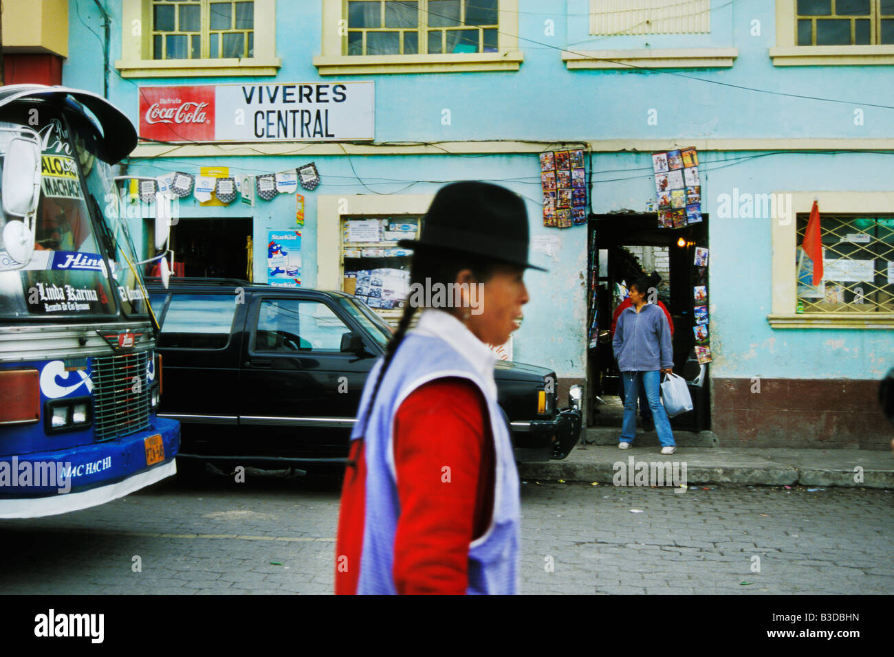 Local woman with traditional fedora hat on street in market in Machachi ...
