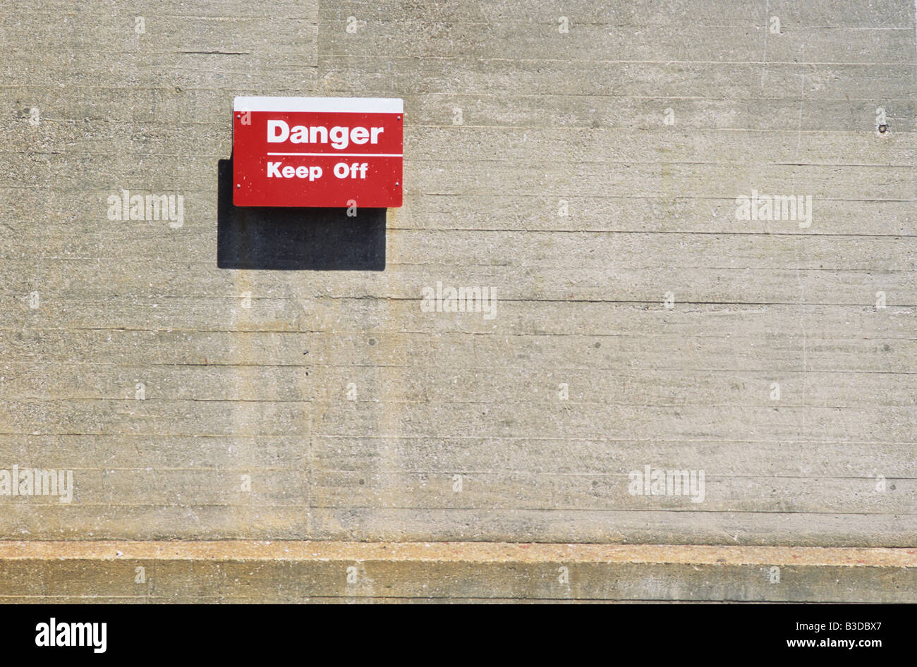Red warning sign danger keep off cement wall Stock Photo - Alamy