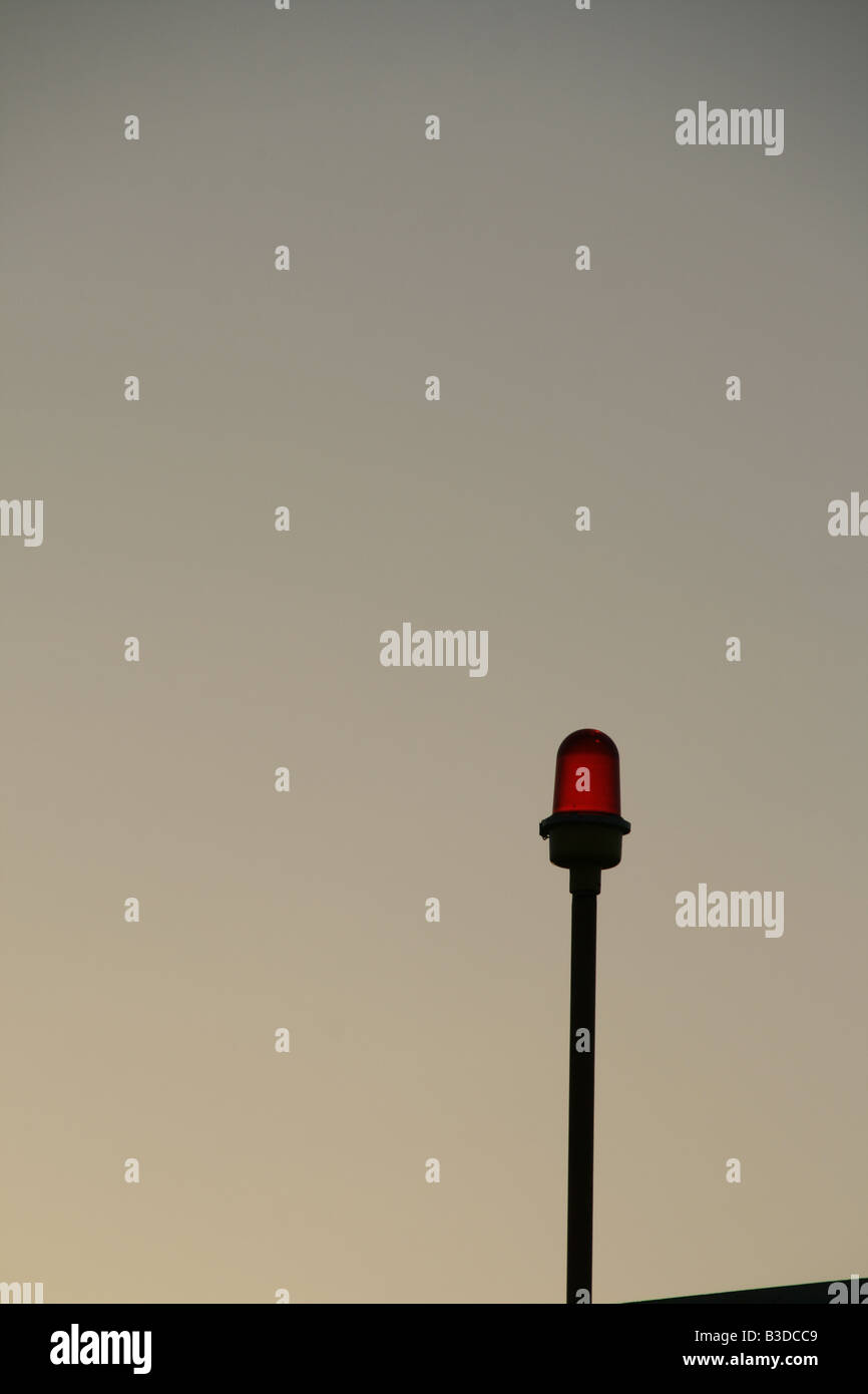 red security light on pole on property at night Stock Photo - Alamy