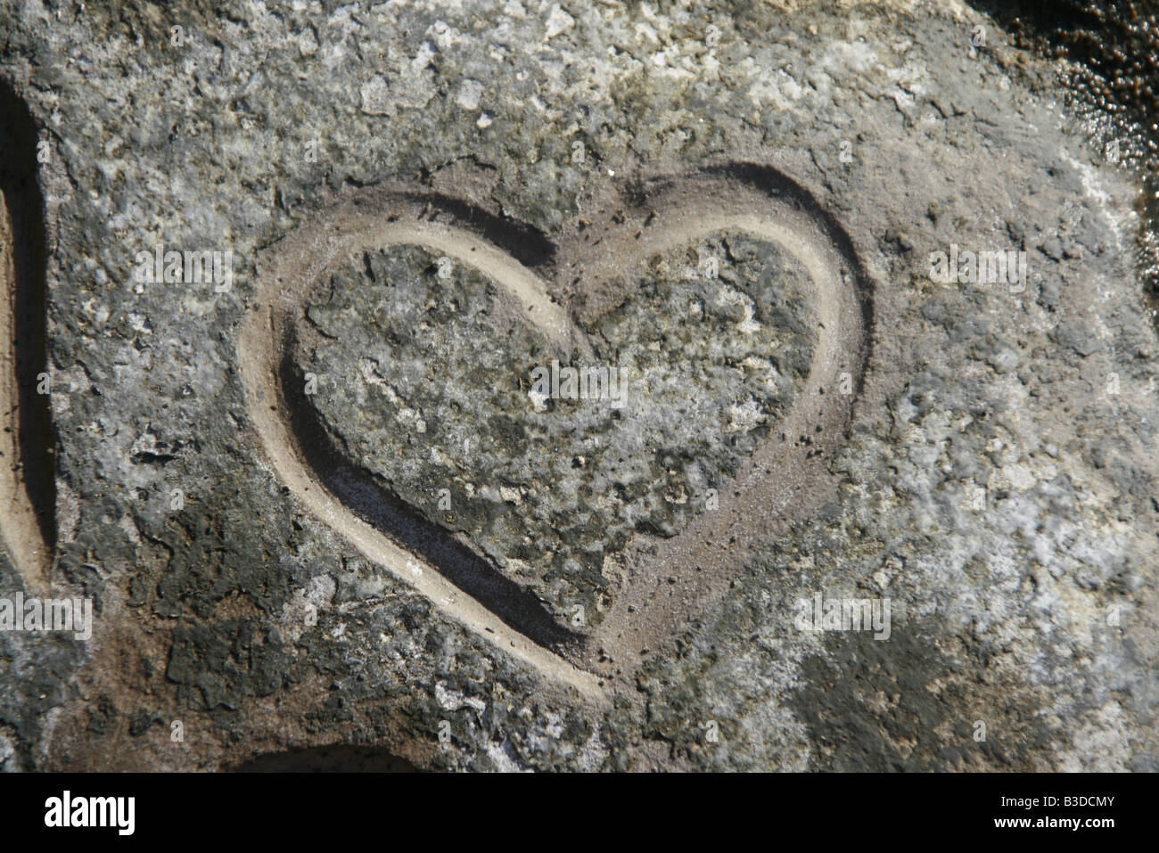 one old heart carved into rock on coast in sun Stock Photo - Alamy