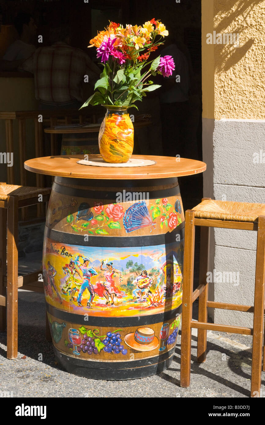 A painted wine barrel serves as a table in front of a wine bar in ...