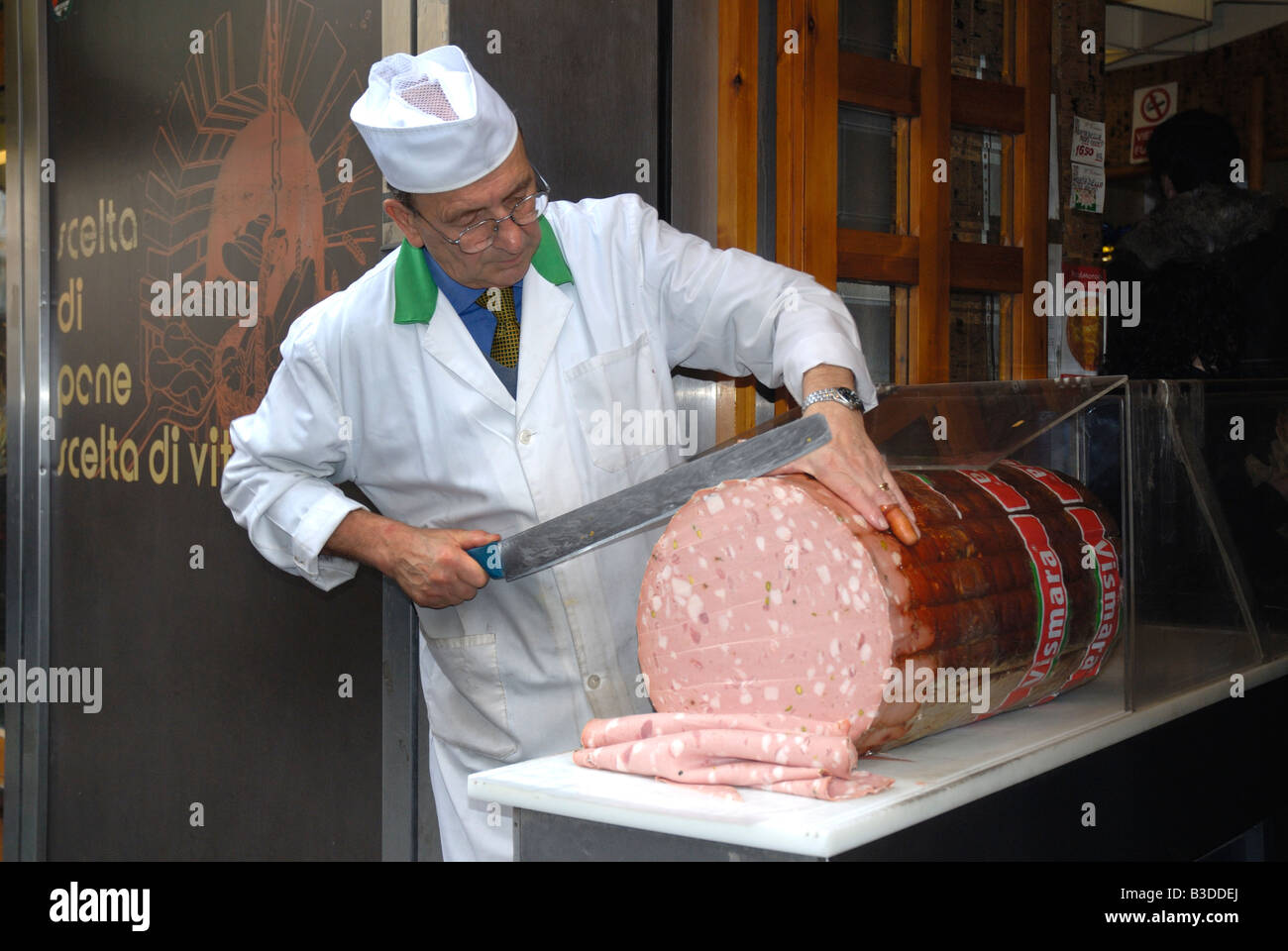 Man slicing large Mortadella sausage near Campo di Fiori market Stock ...