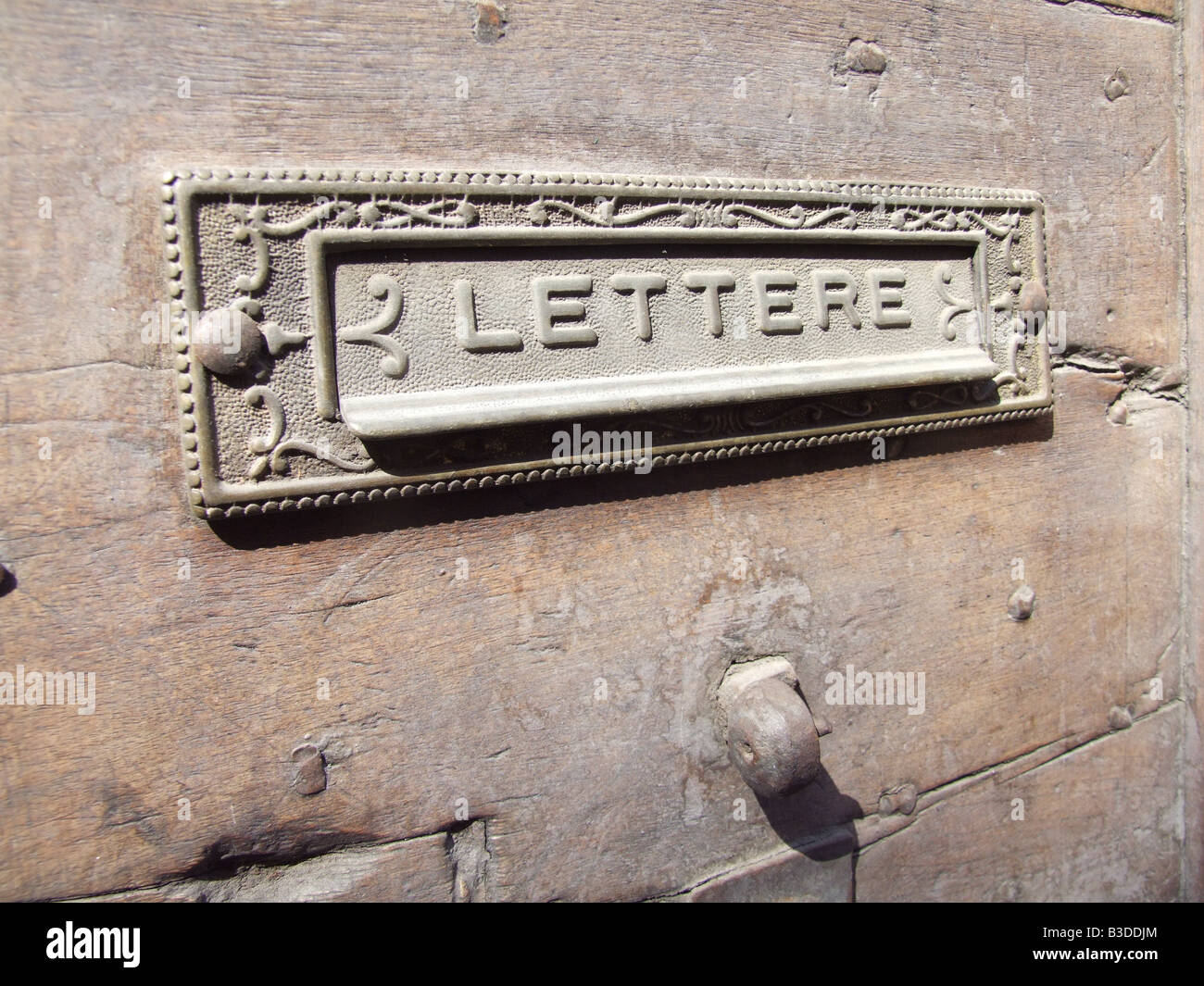 italian letter box and old wooden door Stock Photo - Alamy