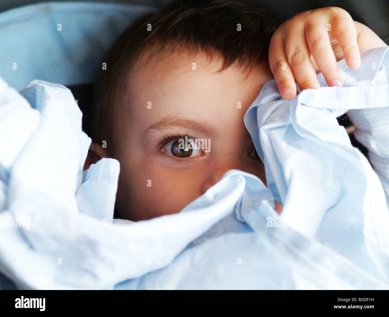 Baby boy hiding in blanket hi-res stock photography and images - Alamy