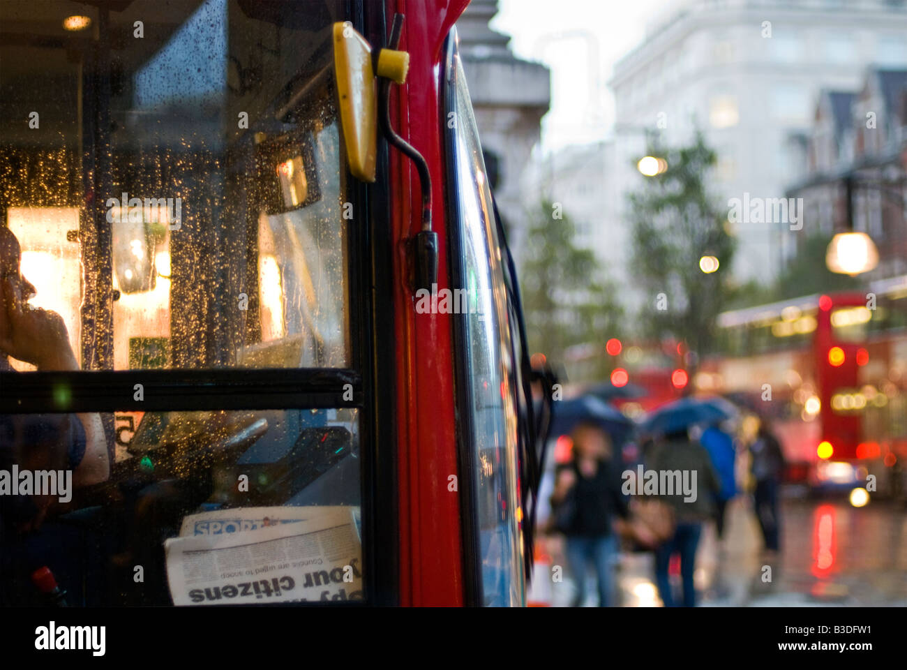 Red London bus in the rain, Oxford Street Stock Photo - Alamy