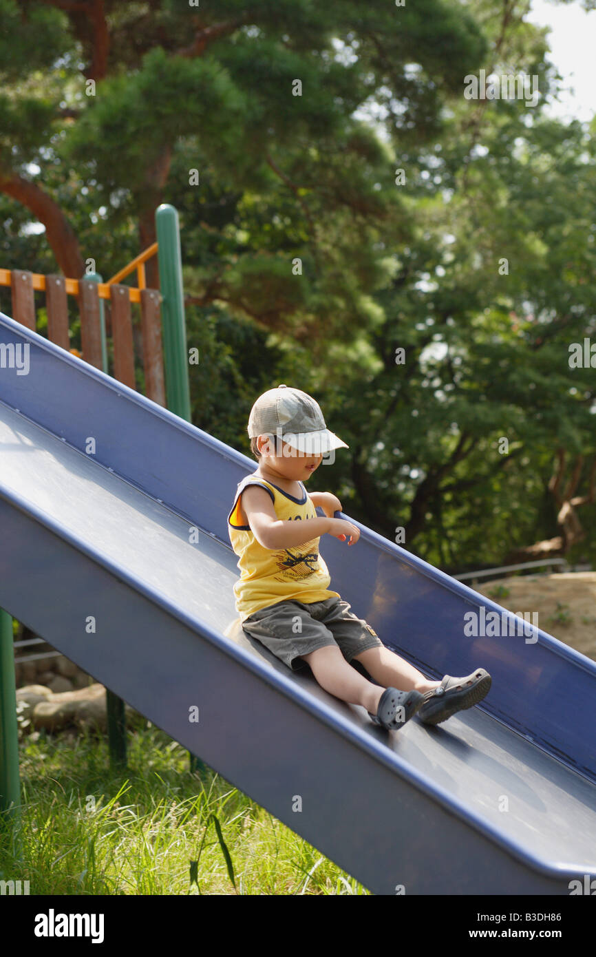 Asian boy sliding down slide hi-res stock photography and images - Alamy