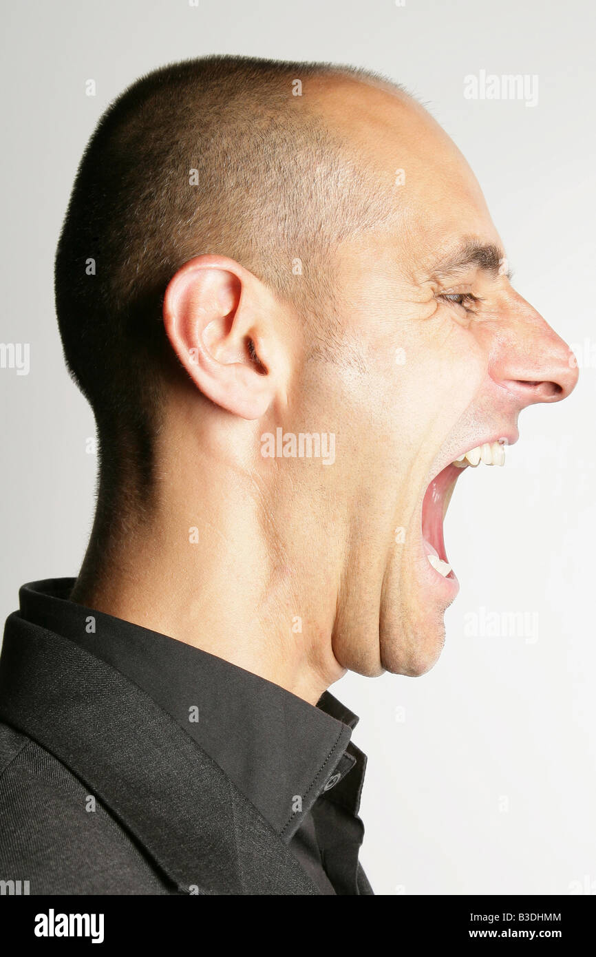 Forty year old man in a busines suit screaming Stock Photo - Alamy