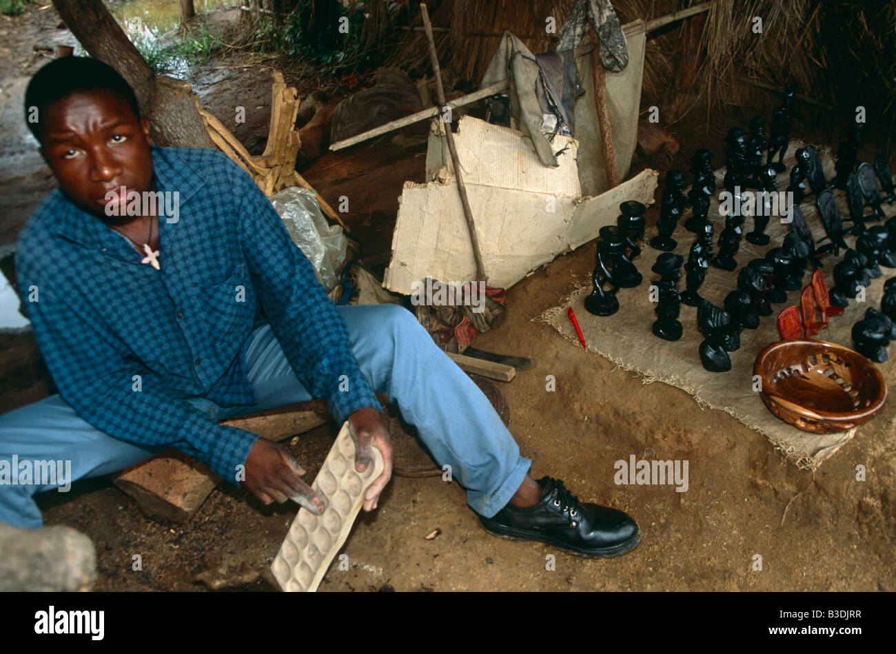 Man making wooden handicrafts in Rwanda Stock Photo - Alamy