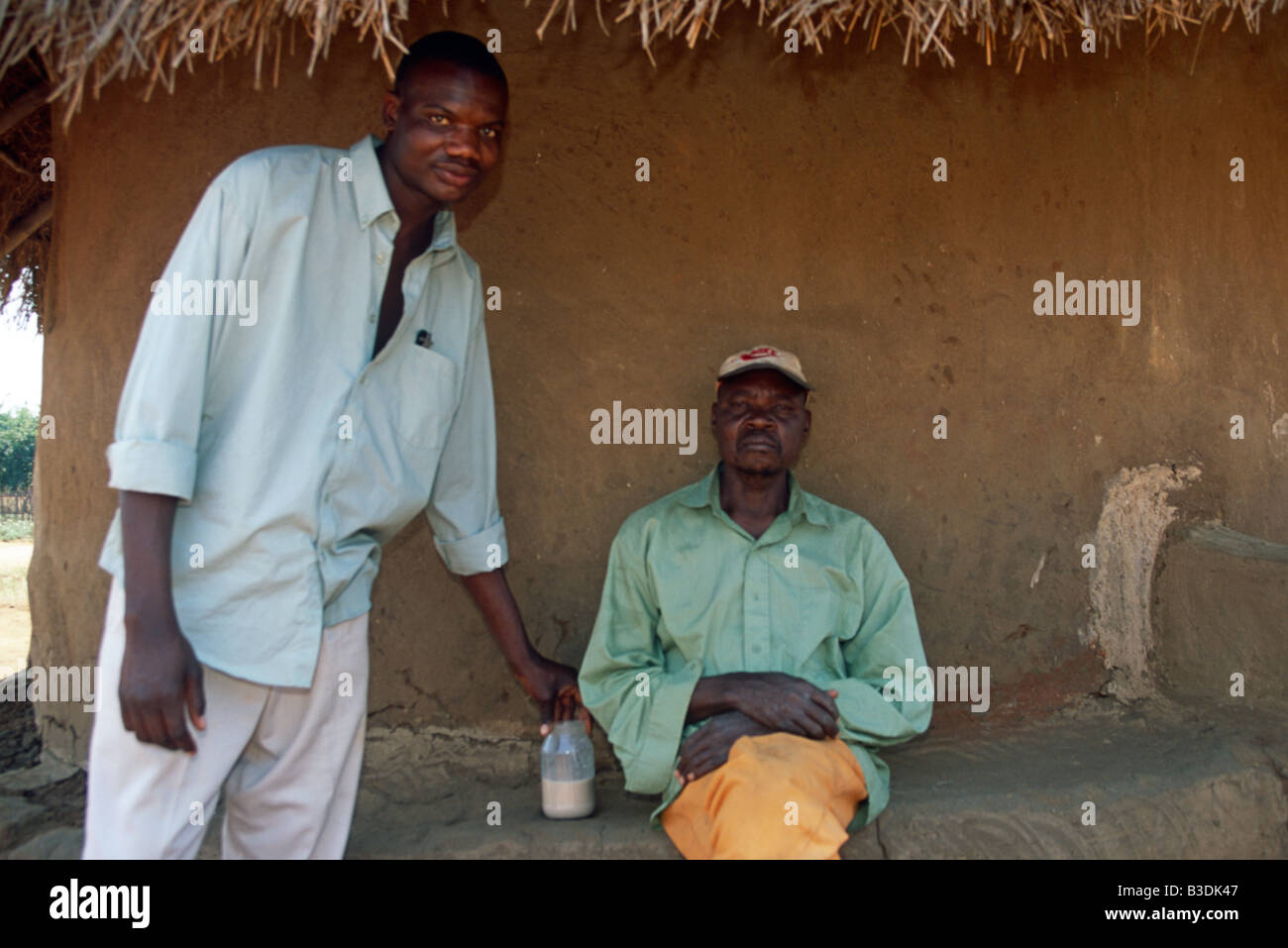 Men outside their hut in South Africa Stock Photo - Alamy