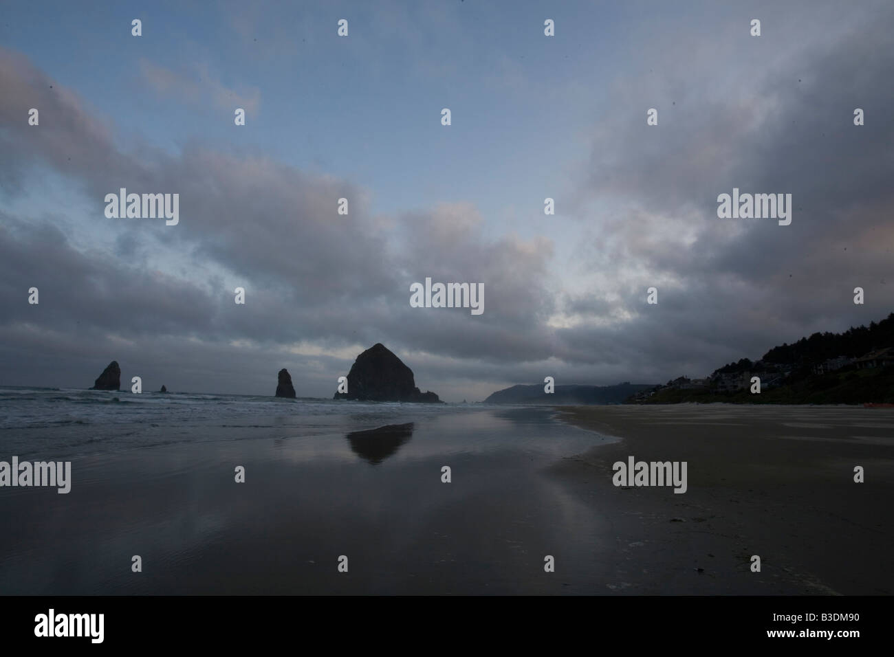 Sunrise and sea stacks on the beach in Cannon Oregon with a dramatic ...
