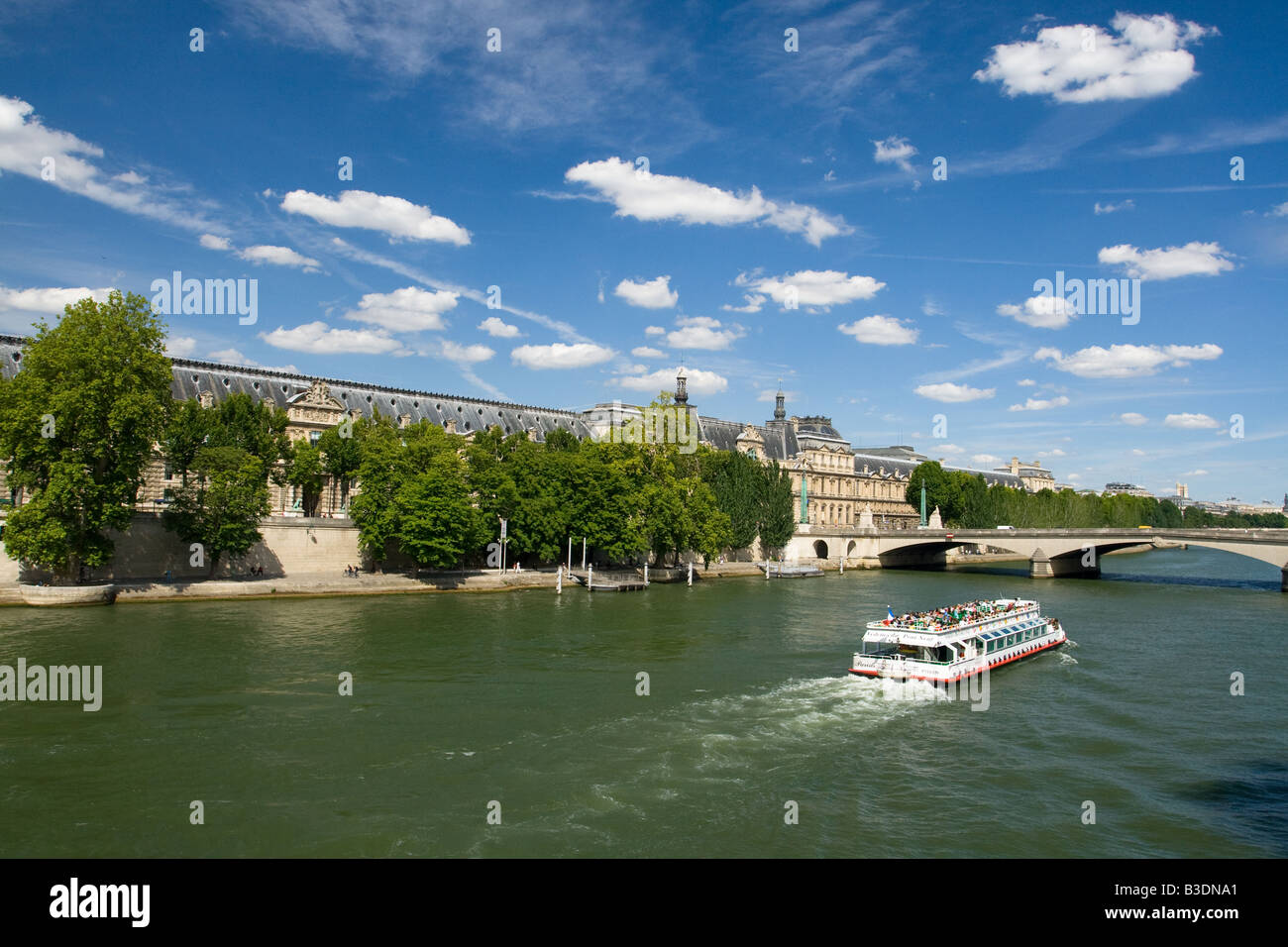 A ferry taking people on a tour of Paris, France on the Seine River ...