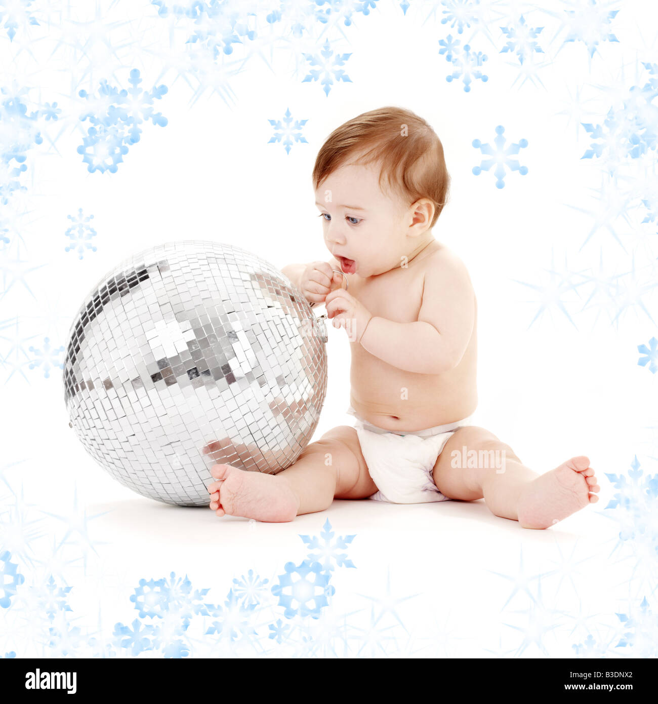 adorable baby boy with big glitterball and snowflakes Stock Photo - Alamy