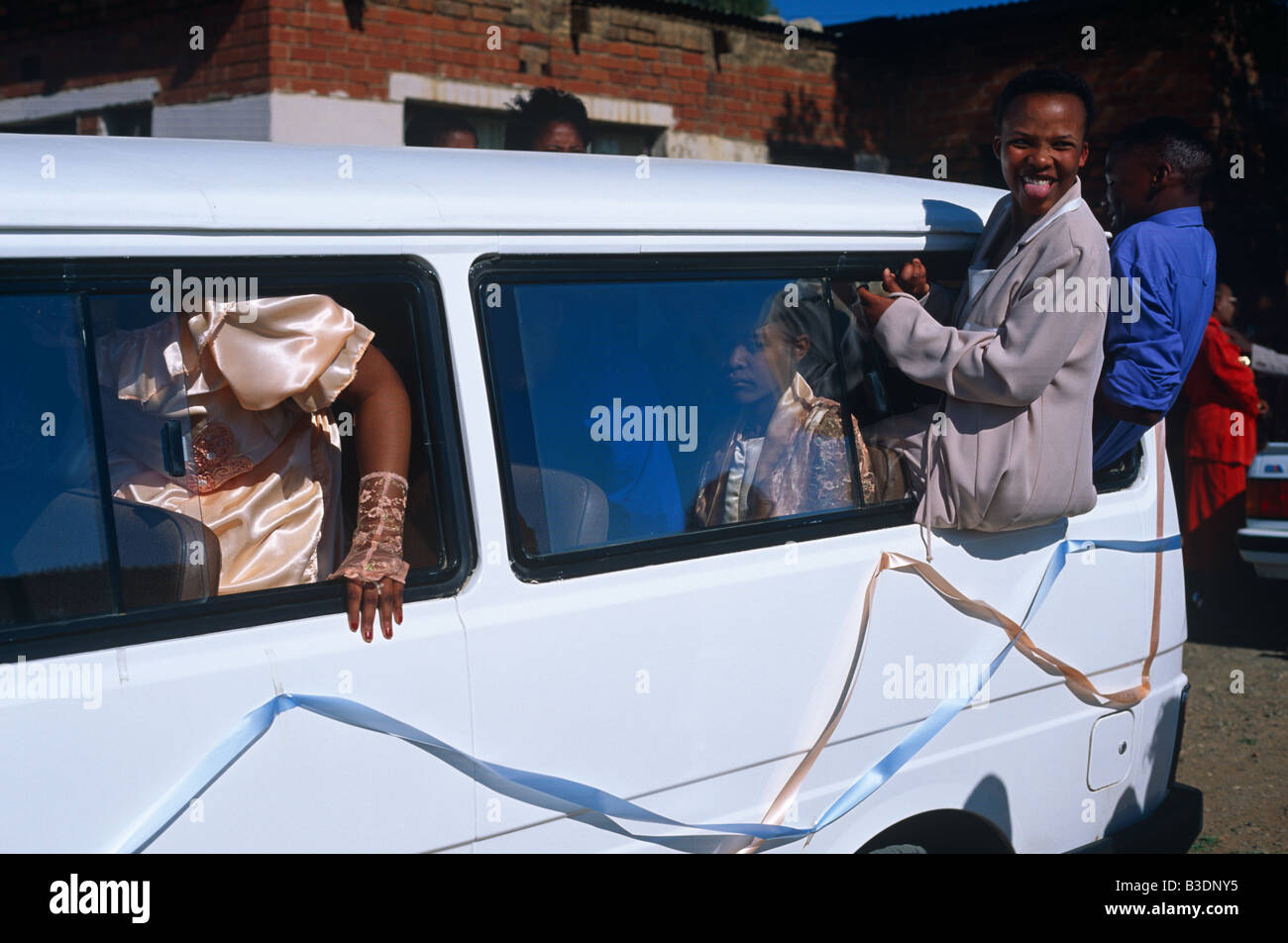 Guests sitting outside vehicle window arriving at wedding party ...