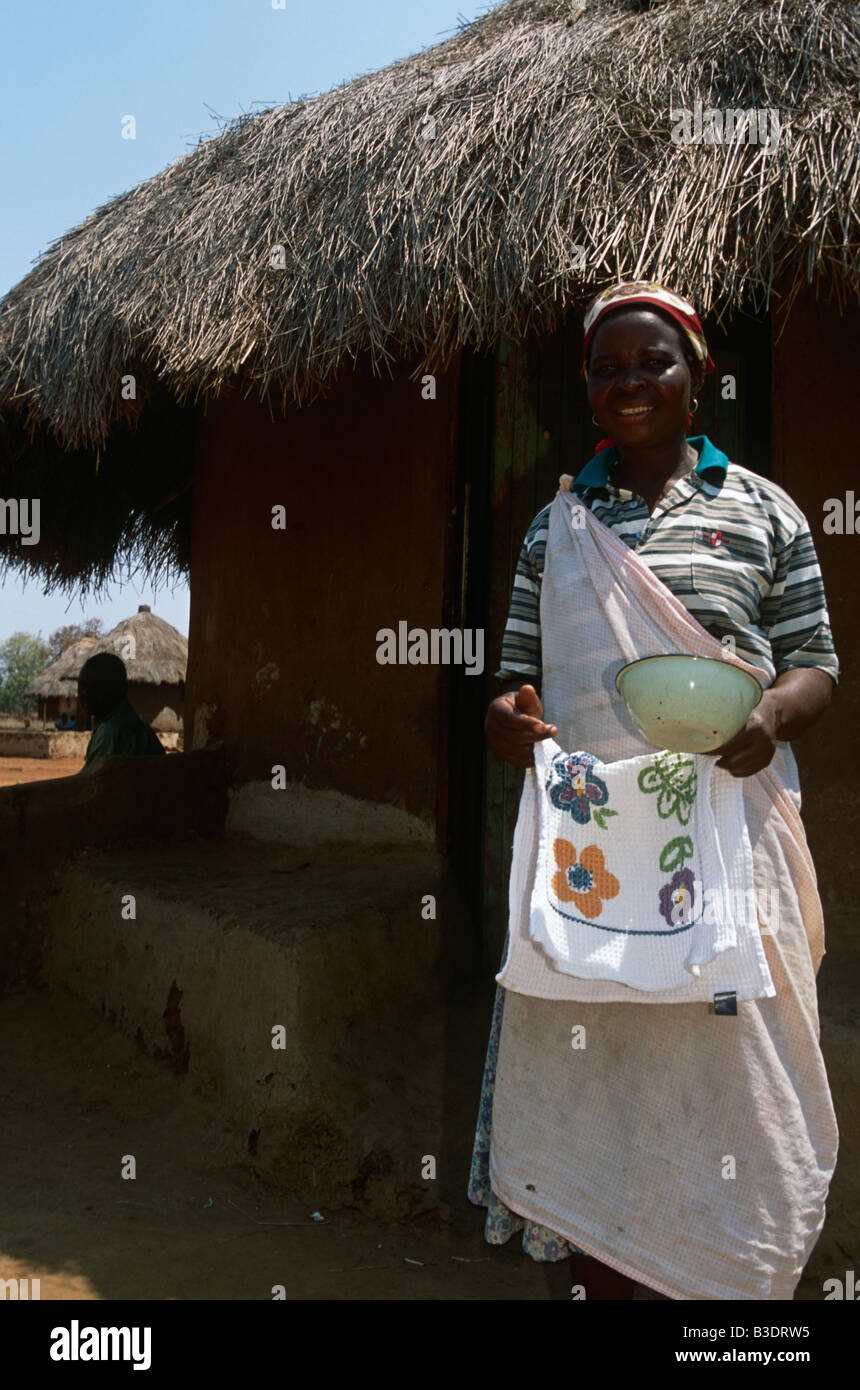 Woman standing outside her hut in Uganda Stock Photo - Alamy