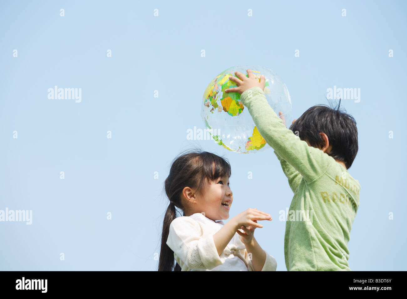Children playing together with a ball Stock Photo - Alamy