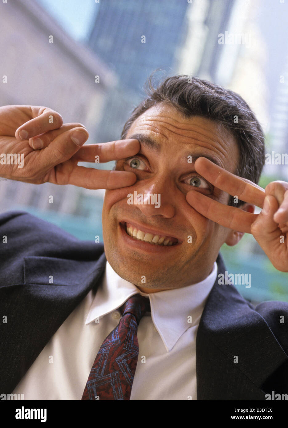 Businessman trying to keep eyes open Stock Photo - Alamy