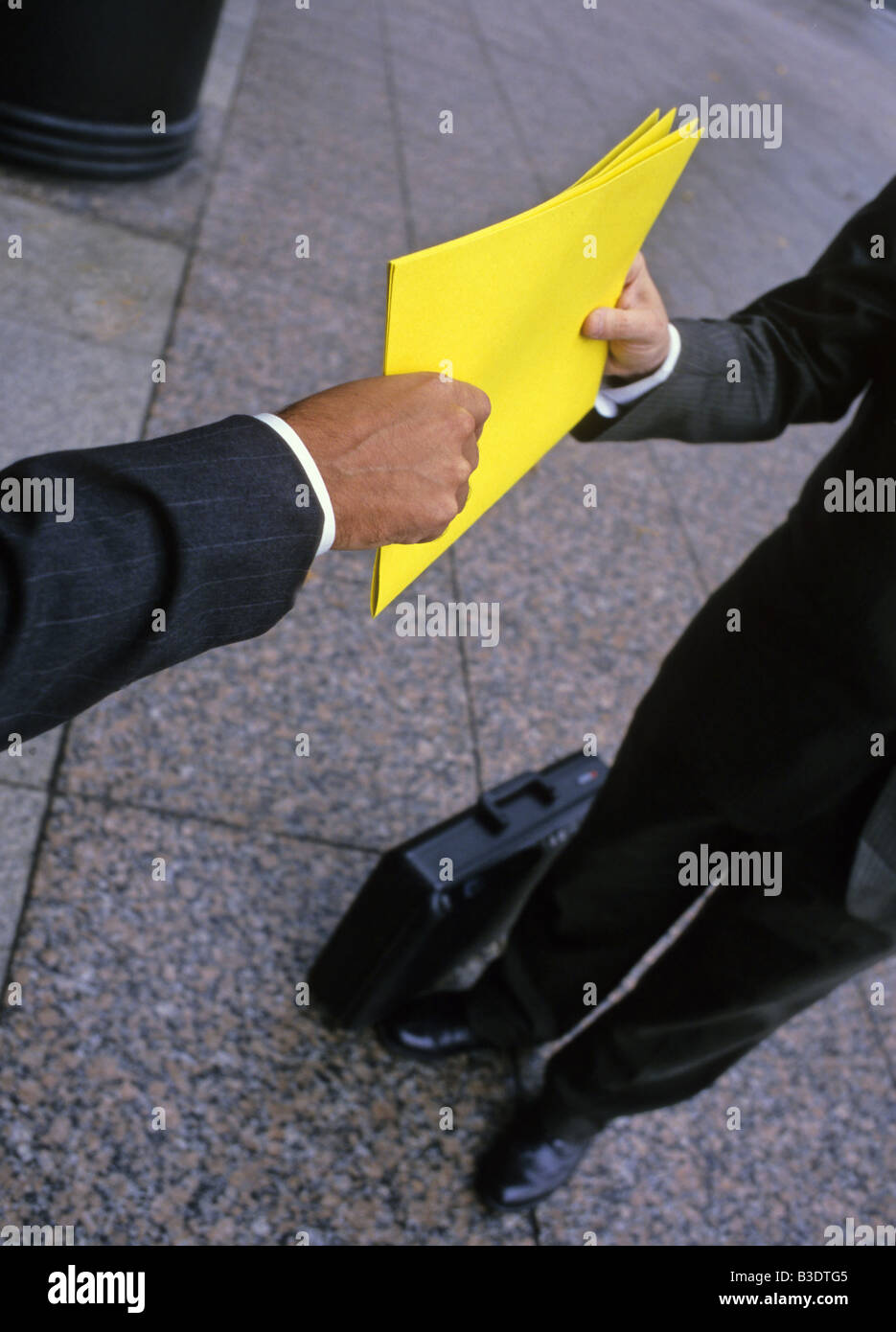Businessmen passing documents Stock Photo - Alamy