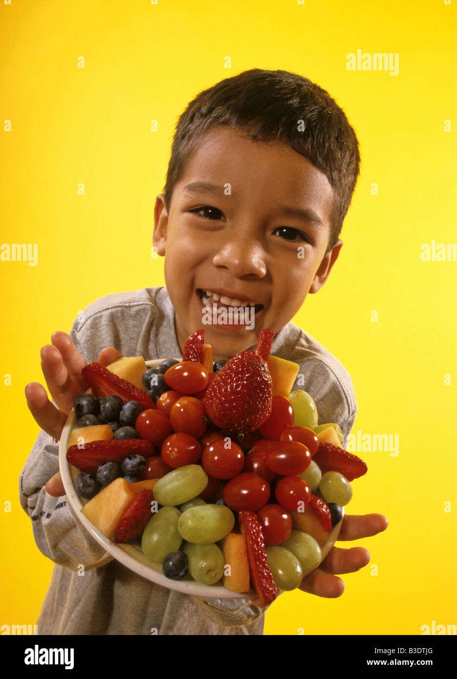 Boy plate full of fruits Stock Photo - Alamy