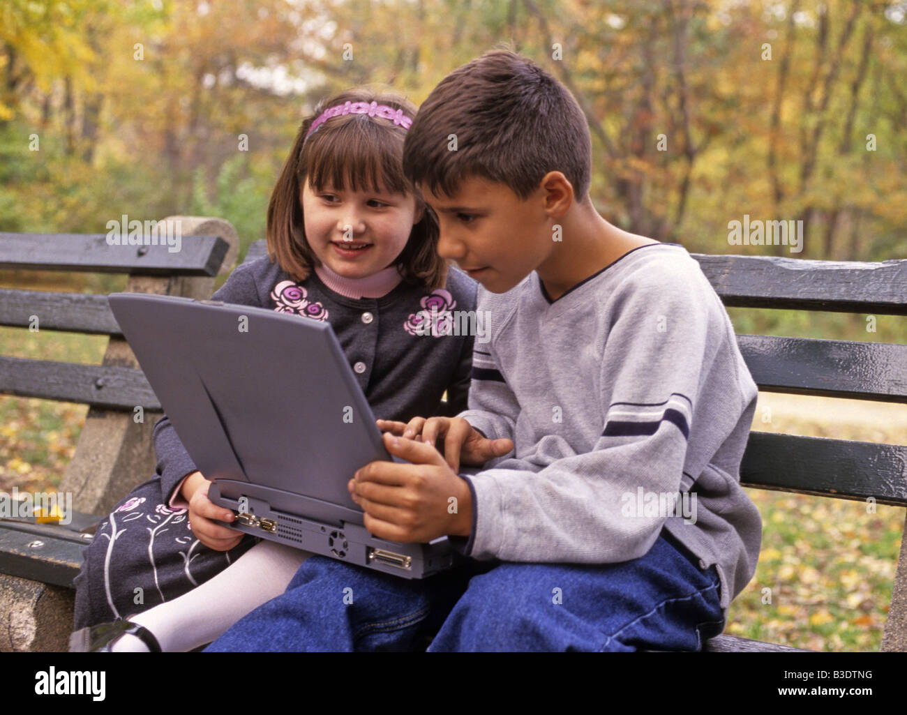 Boy and girl with laptop Stock Photo - Alamy