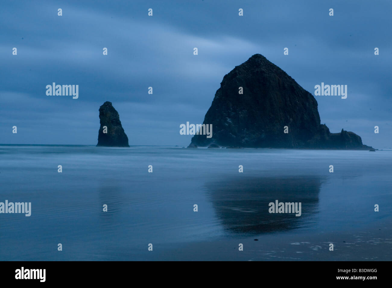 Sunrise and sea stacks on the beach in Cannon Oregon with a dramatic ...