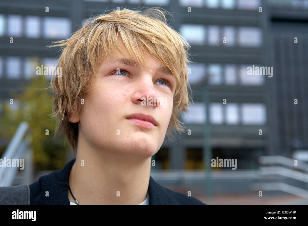 Portrait of hopeful teenage boy outdoor in city contemplating Stock ...