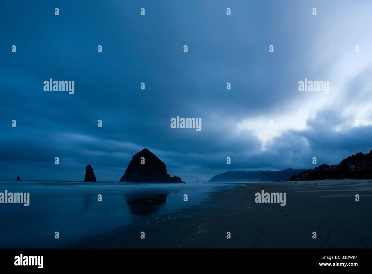 Sunrise and sea stacks on the beach in Cannon Oregon with a dramatic ...