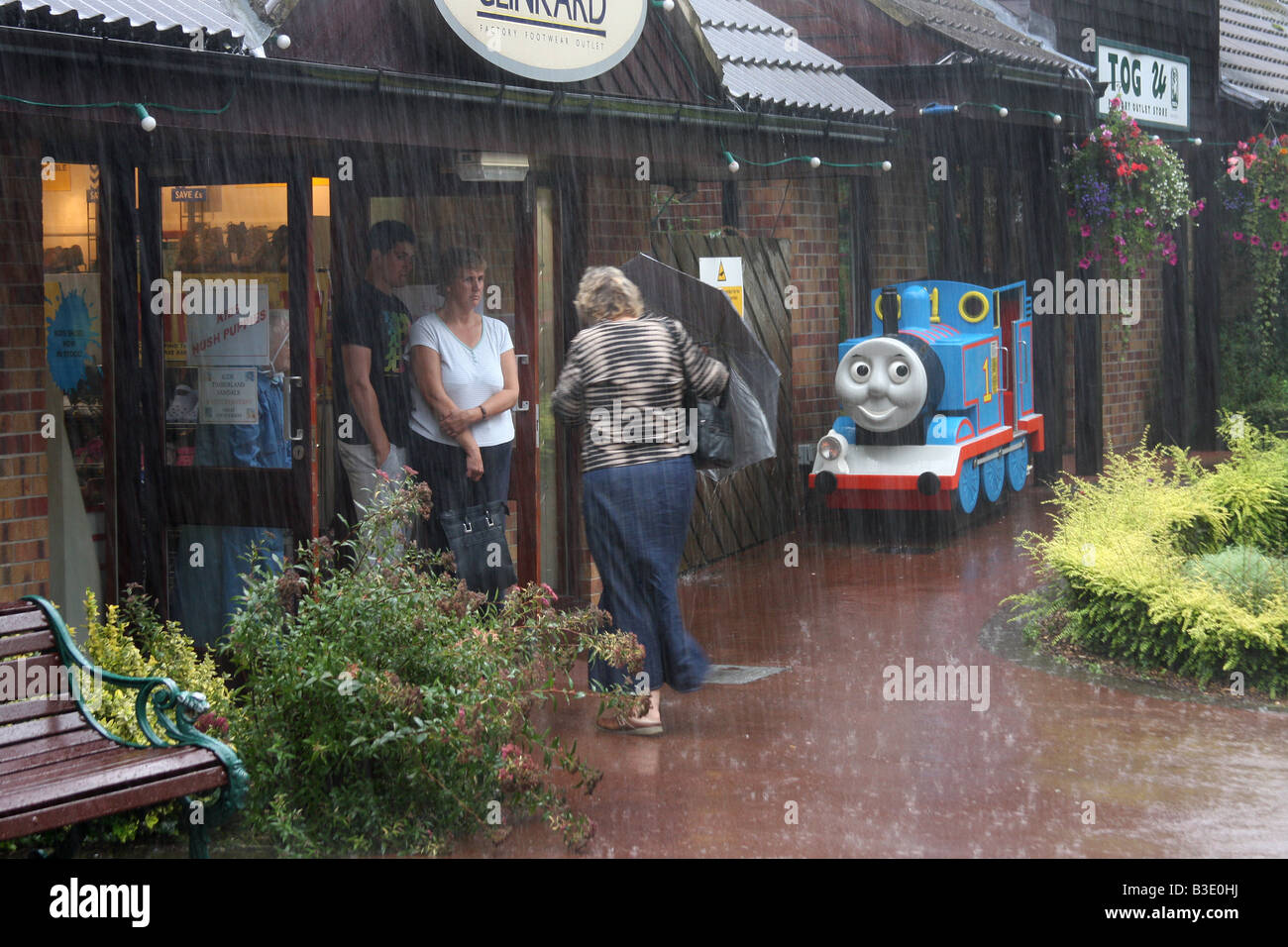 Very heavy fall of rain causing people to seek cover in a shopping ...