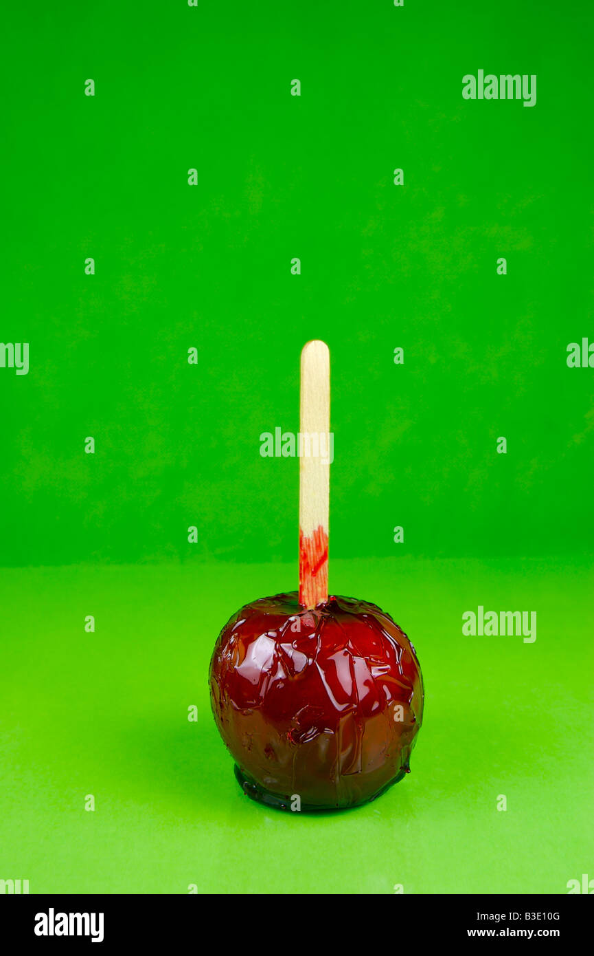 Candy apples isolated against a green background Stock Photo - Alamy