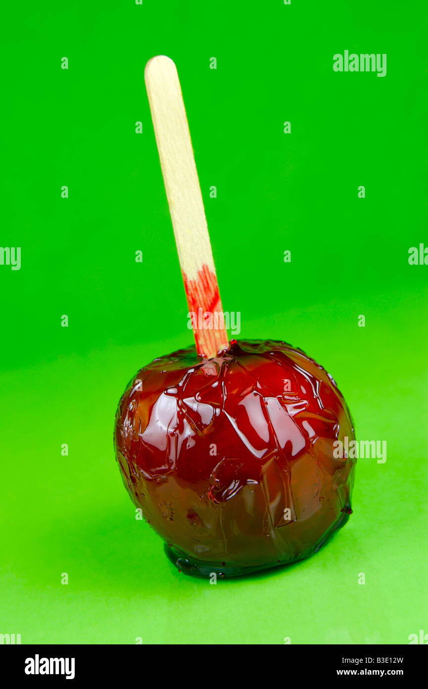 Candy apples isolated against a green background Stock Photo - Alamy