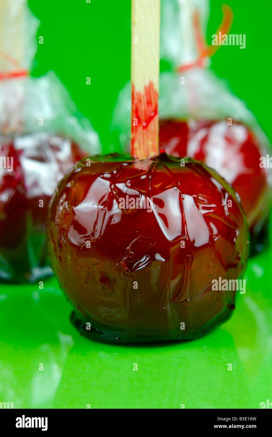 Candy apples isolated against a green background Stock Photo - Alamy