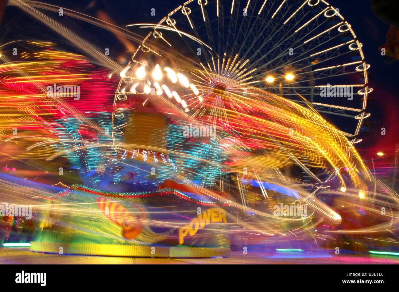 fairground ride with Ferris wheel at dusk Tilburg Netherlands Holland ...