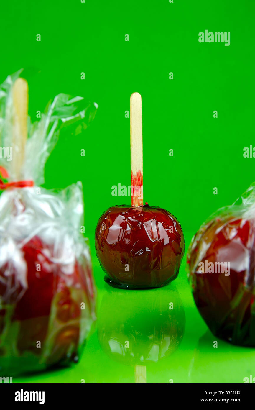 Candy apples isolated against a green background Stock Photo - Alamy